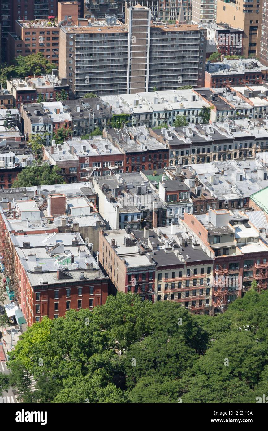A view of the roofs of the Upper East Side of Manhattan with trees and ...