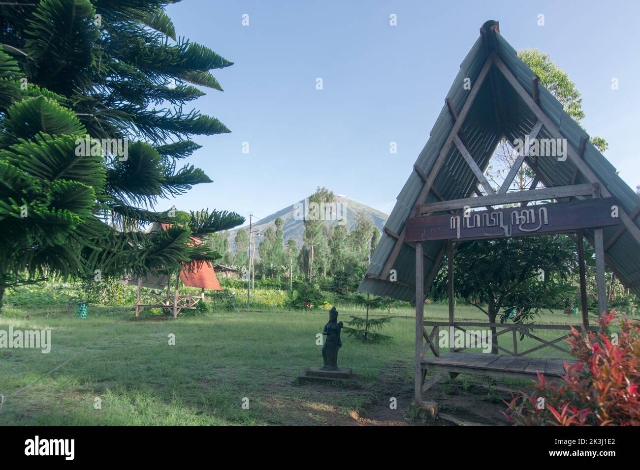 A landscape with trees, grass and outdoor garden alcove on a sunny day ...