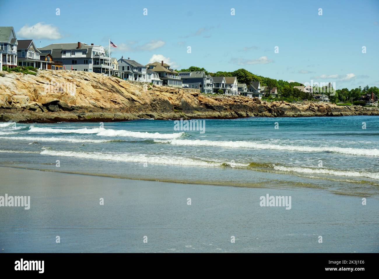 A beautiful scenery of York Beach in the gulf of Maine next to houses ...