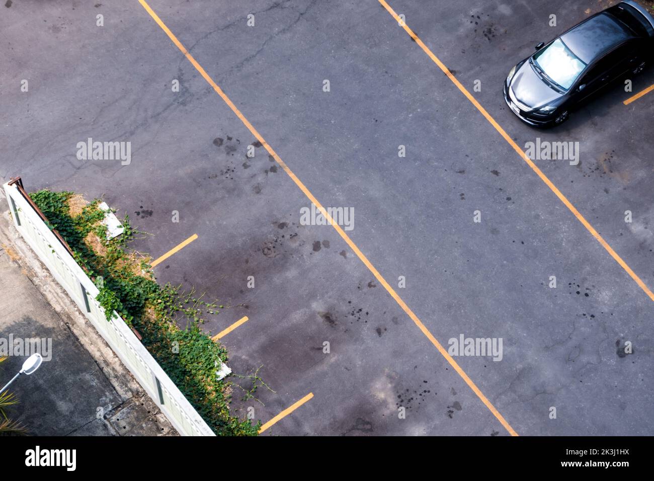 High angle view of a weed-covered parking lot Stock Photo - Alamy