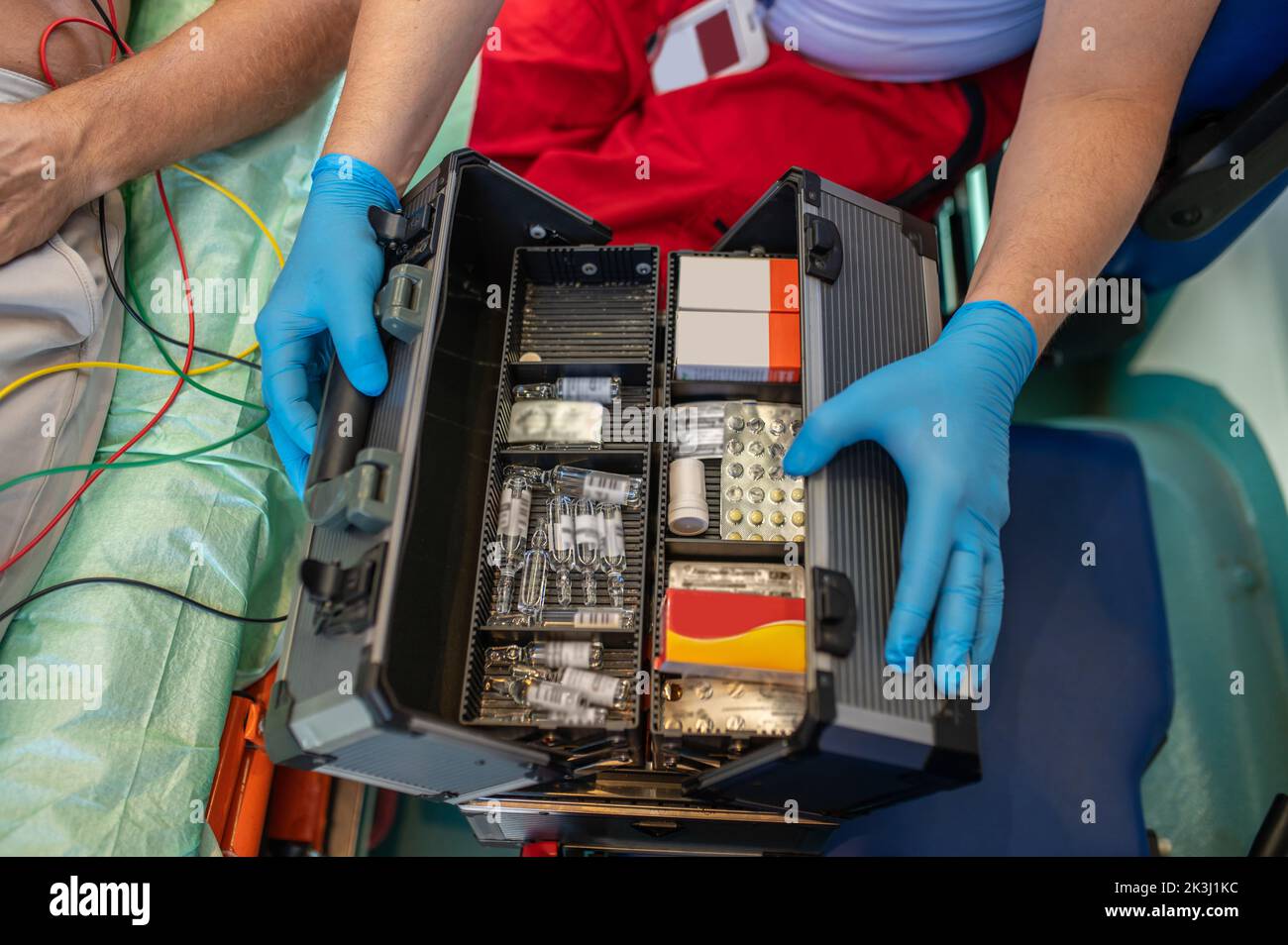 Paramedic choosing a medicine for administering to a sick person Stock ...