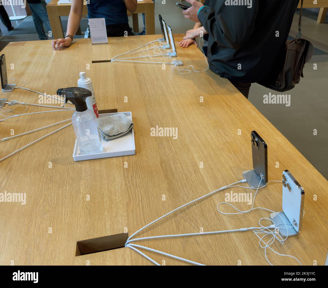 Paris, France - Sep 16, 2022: Female worker selling new phone: The Apple Computers iPhone 14, 14 ...