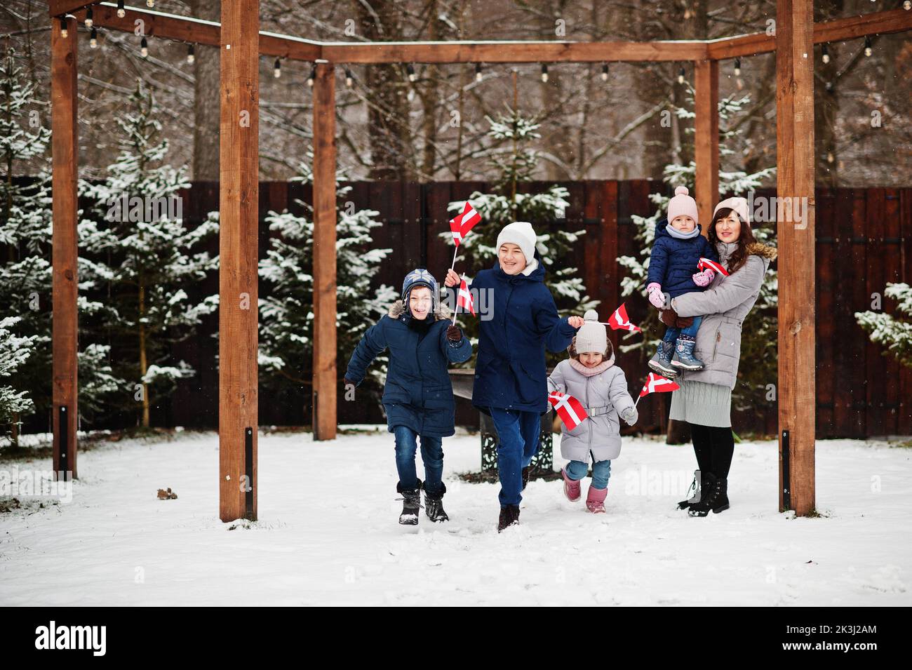 Family with Denmark flags outdoor in winter. Travel to Scandinavian ...