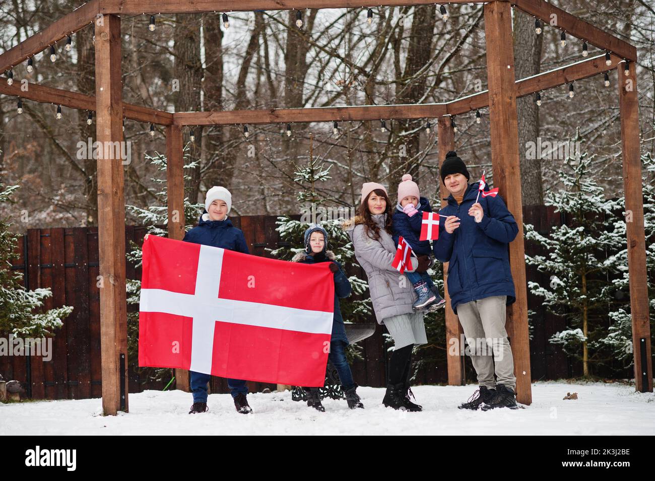 Family with Denmark flags outdoor in winter. Travel to Scandinavian ...
