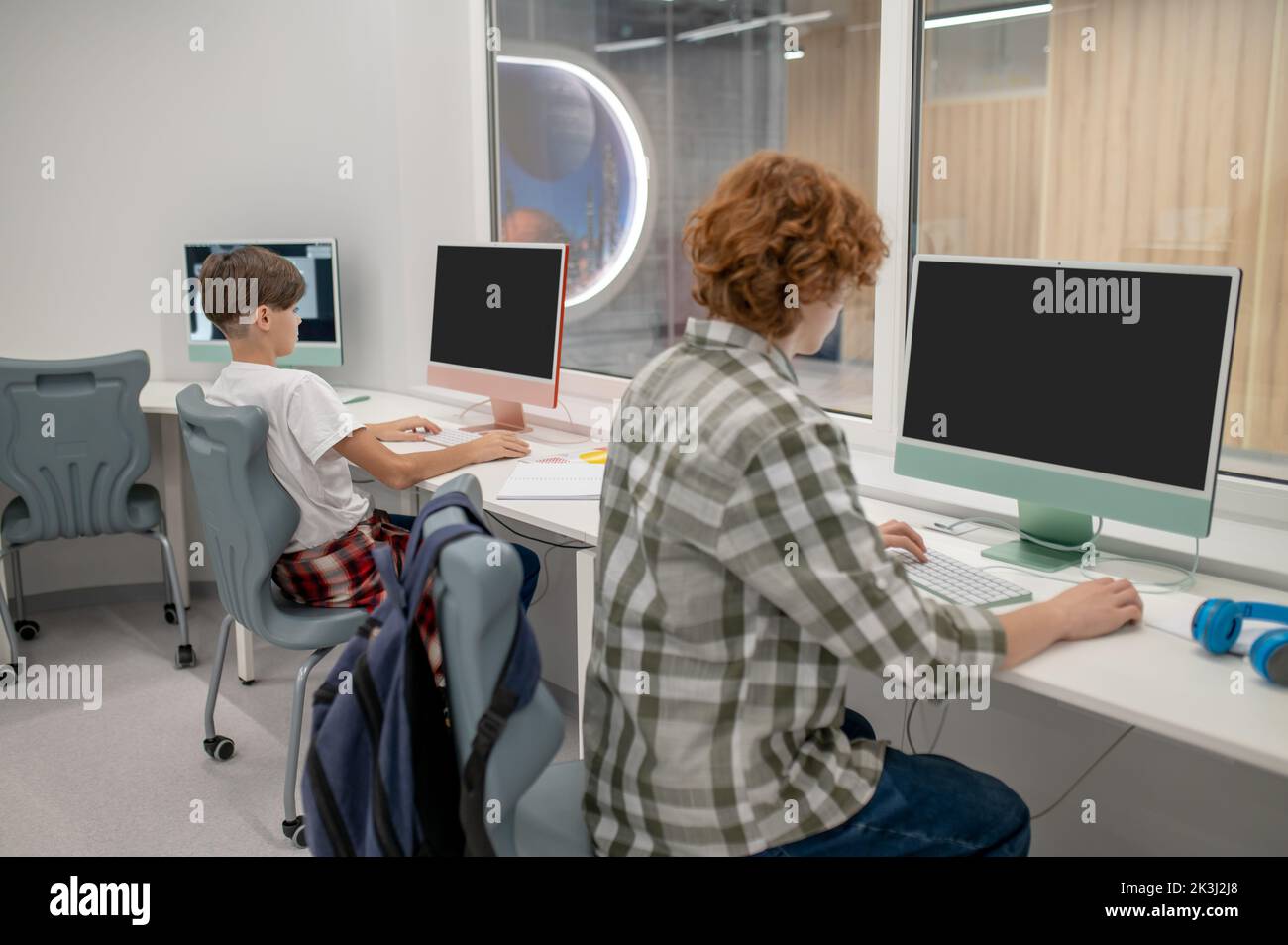 Schoolboys working on computers at IT lesson at school Stock Photo - Alamy
