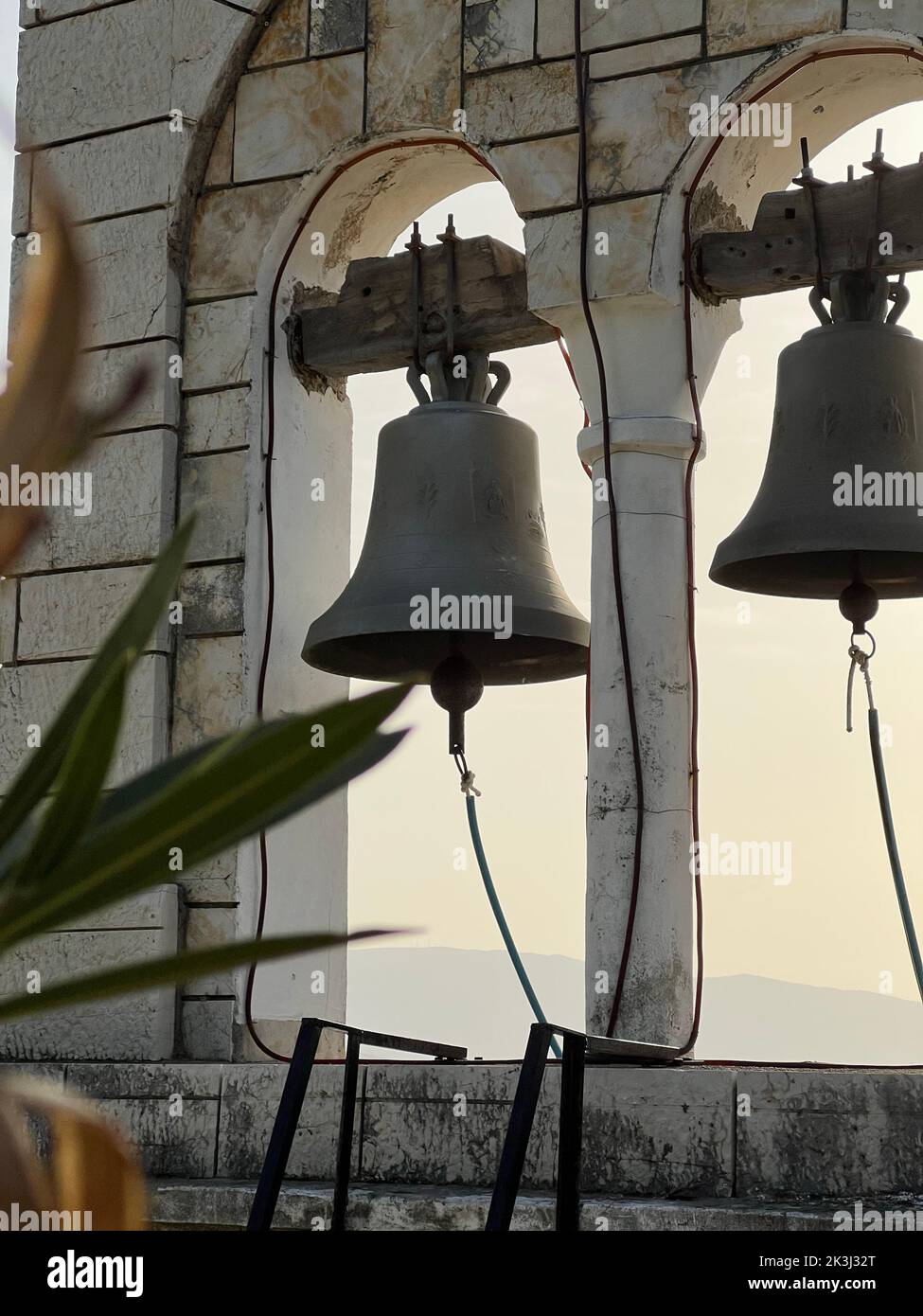 A vertical shot of church bells with a sunset in the background Stock ...