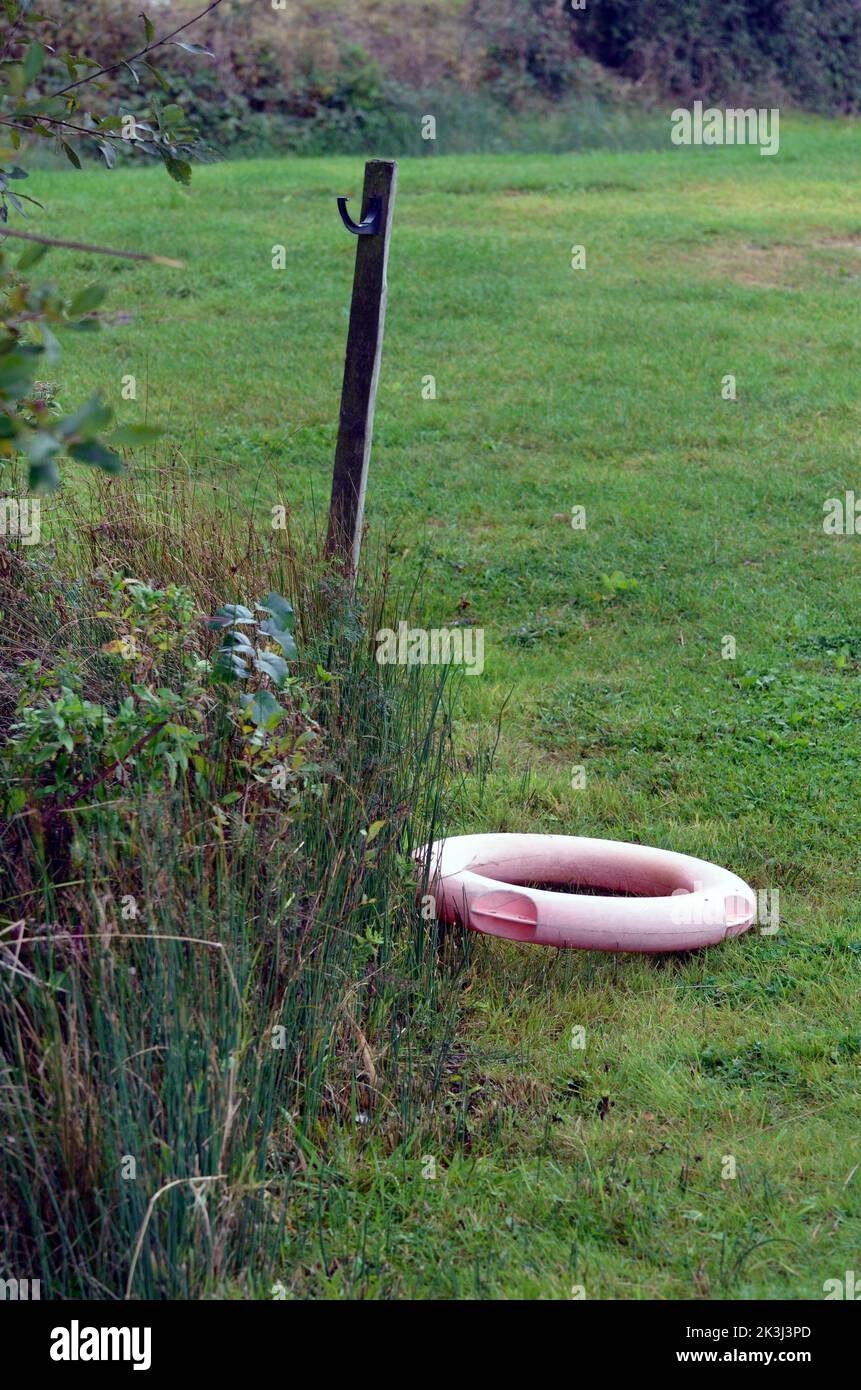 life belt fallen off supporting pole Stock Photo - Alamy