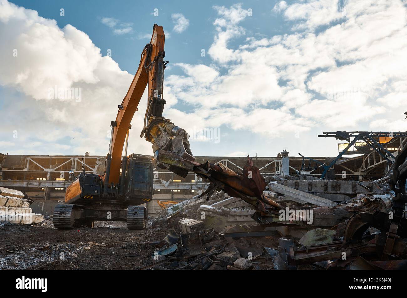 Excavator destroyer removes debris Building demolition Stock Photo - Alamy