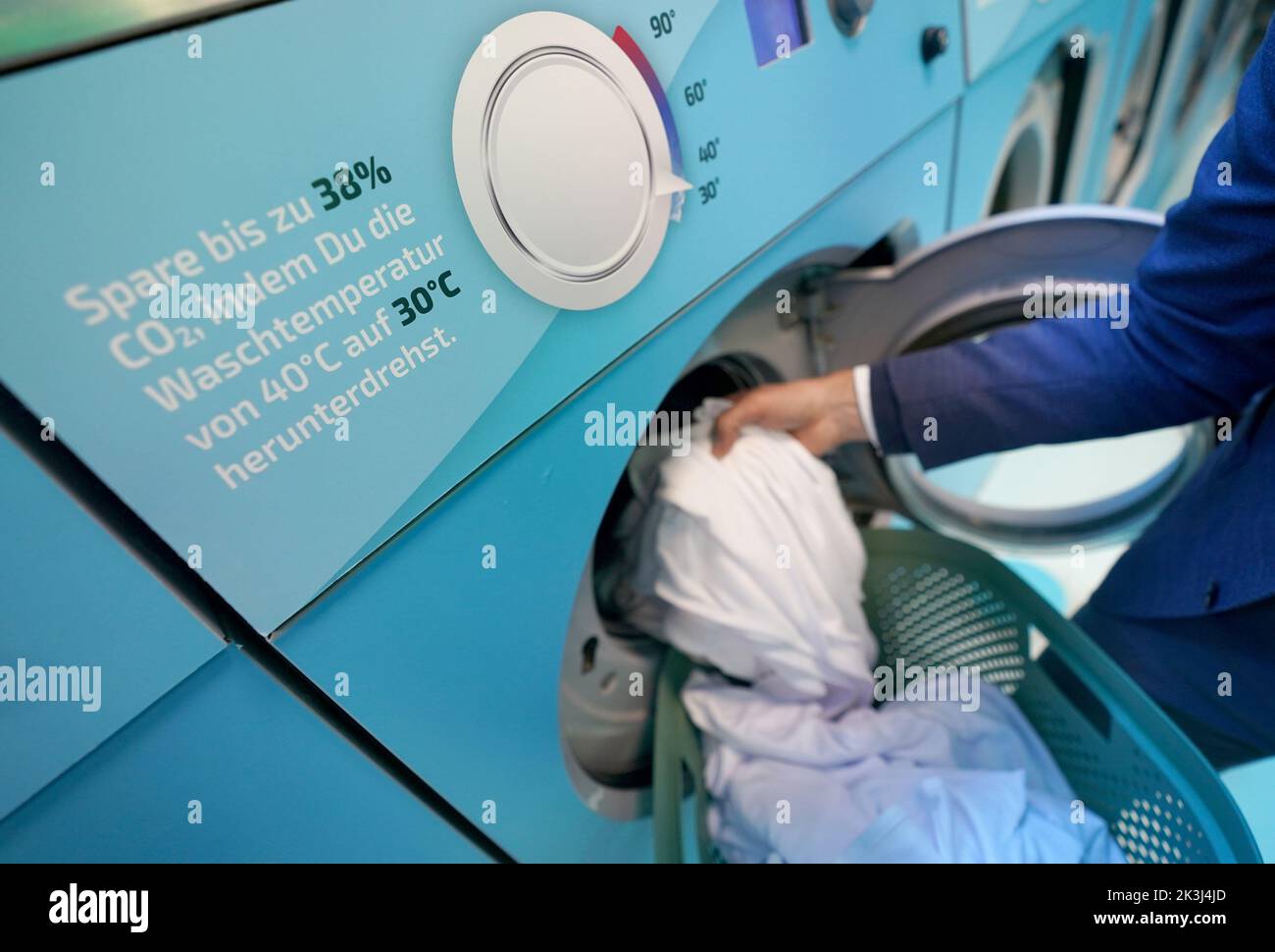 Hamburg, Germany. 27th Sep, 2022. A man fills a washing machine during ...