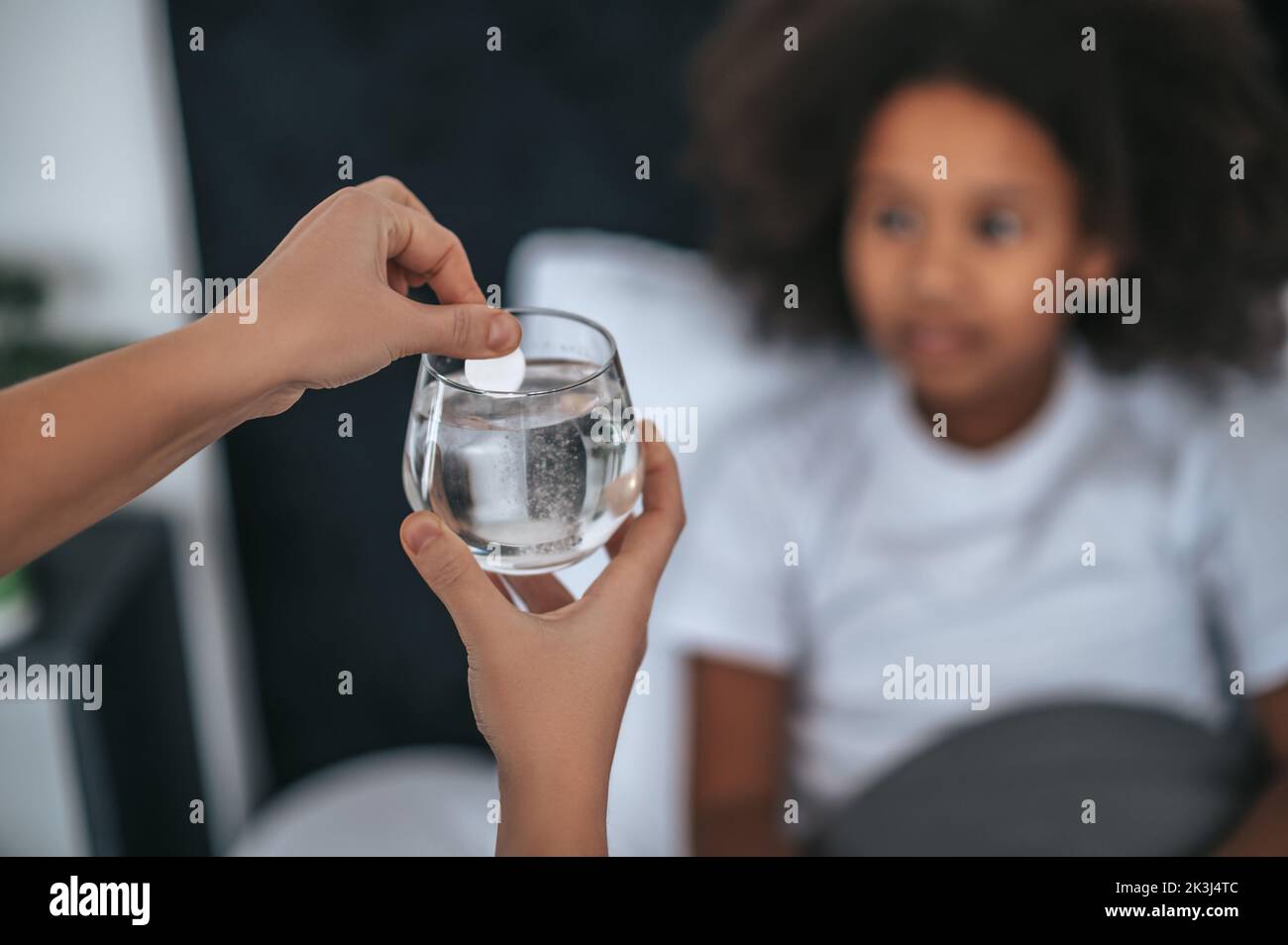 Cute girl talking a soluble pill while being sick Stock Photo - Alamy
