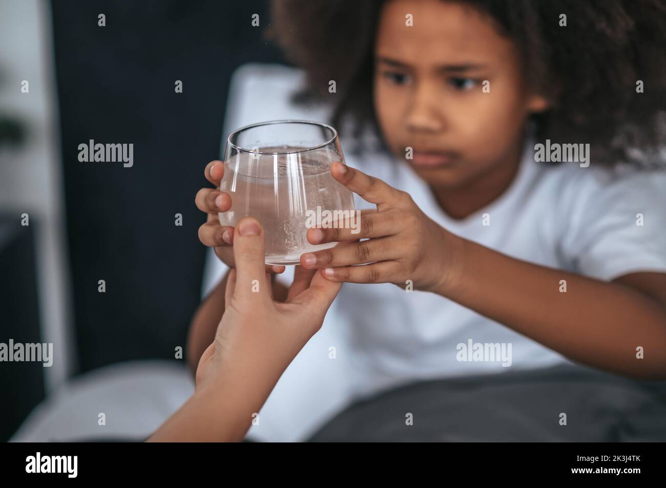 Cute girl talking a soluble pill while being sick Stock Photo - Alamy