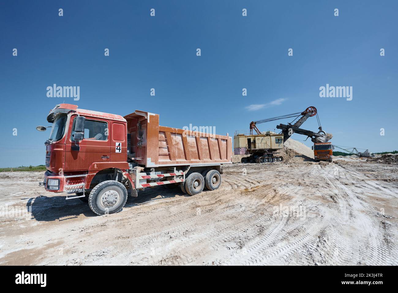 Red tipper truck stands at open chalk quarry at summer day Stock Photo ...