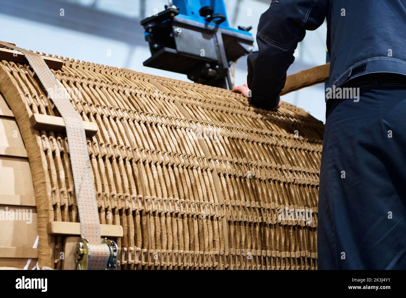 Worker wraps insulation fabric onto transformer core Stock Photo - Alamy