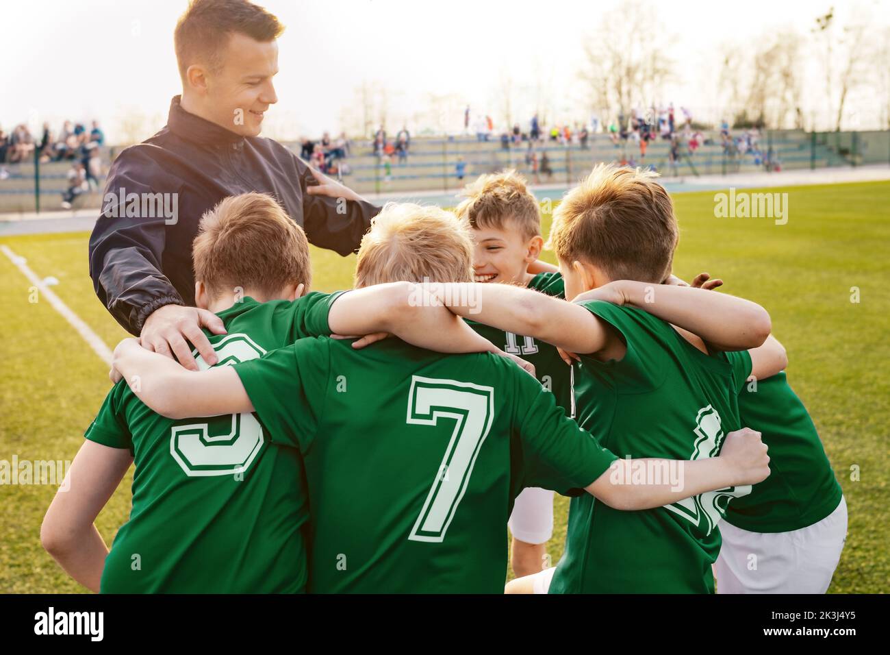 Sports Competition for Children. Boys Sport Team Huddle. Coach and Young Football Players ...