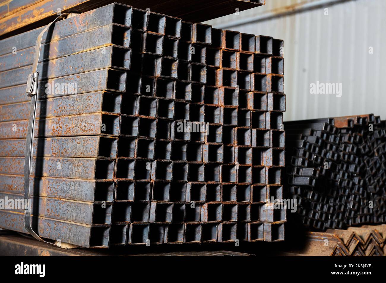 Square tubing pile on rack unit in cold factory warehouse Stock Photo ...