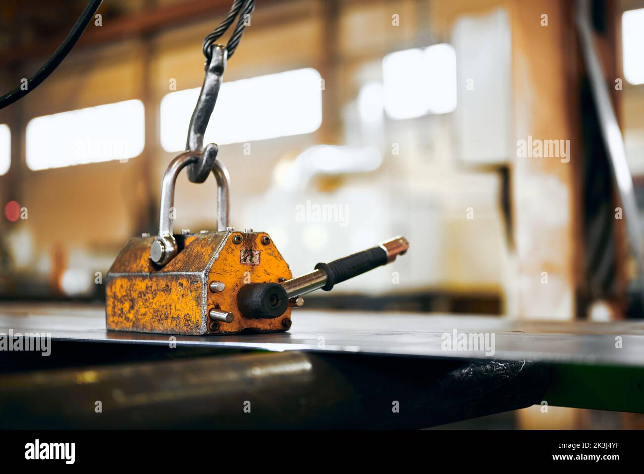 Magnetic grab to transport metal sheets in workshop Stock Photo - Alamy