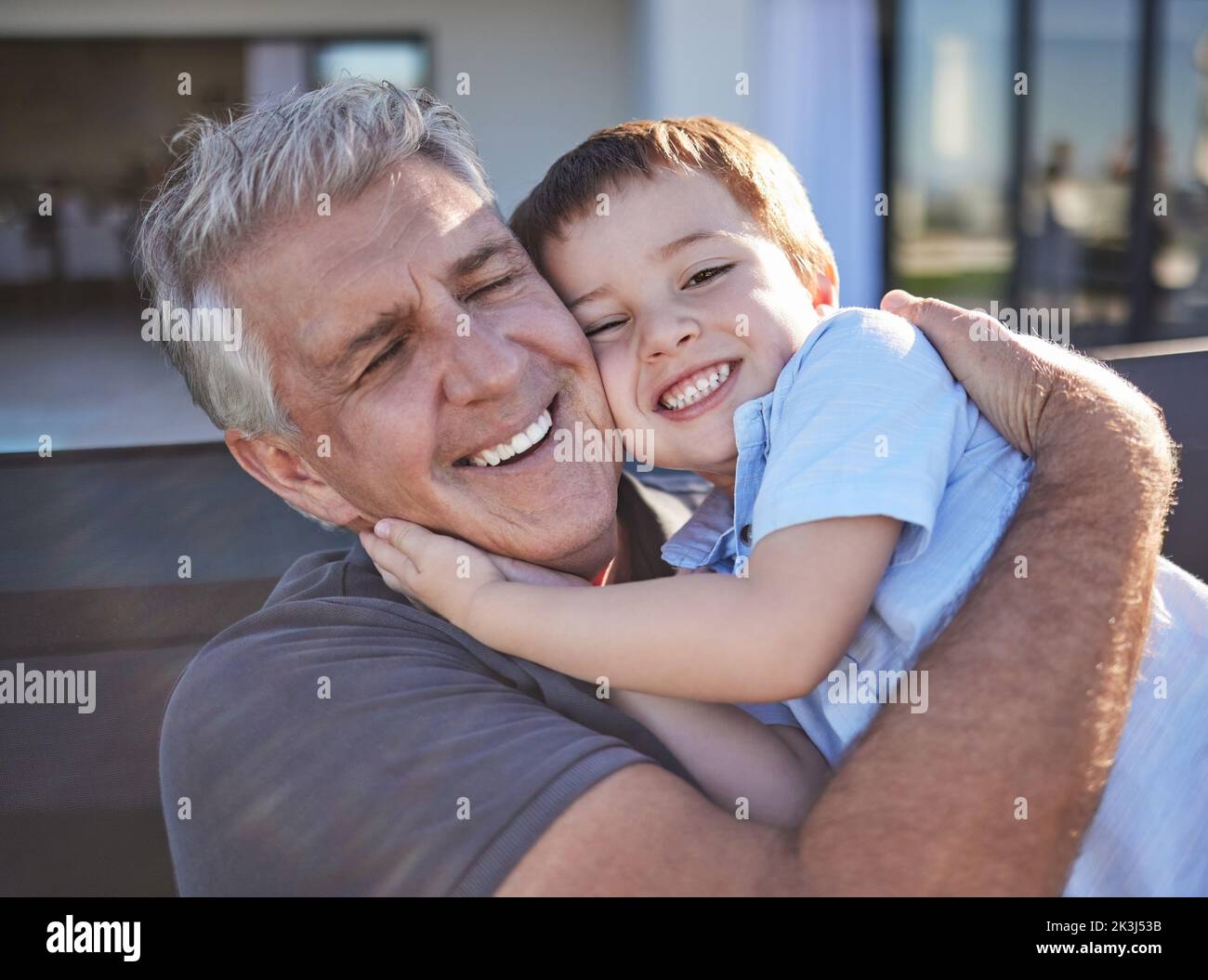 Happy, smile and grandfather hugging his grandchild while playing ...