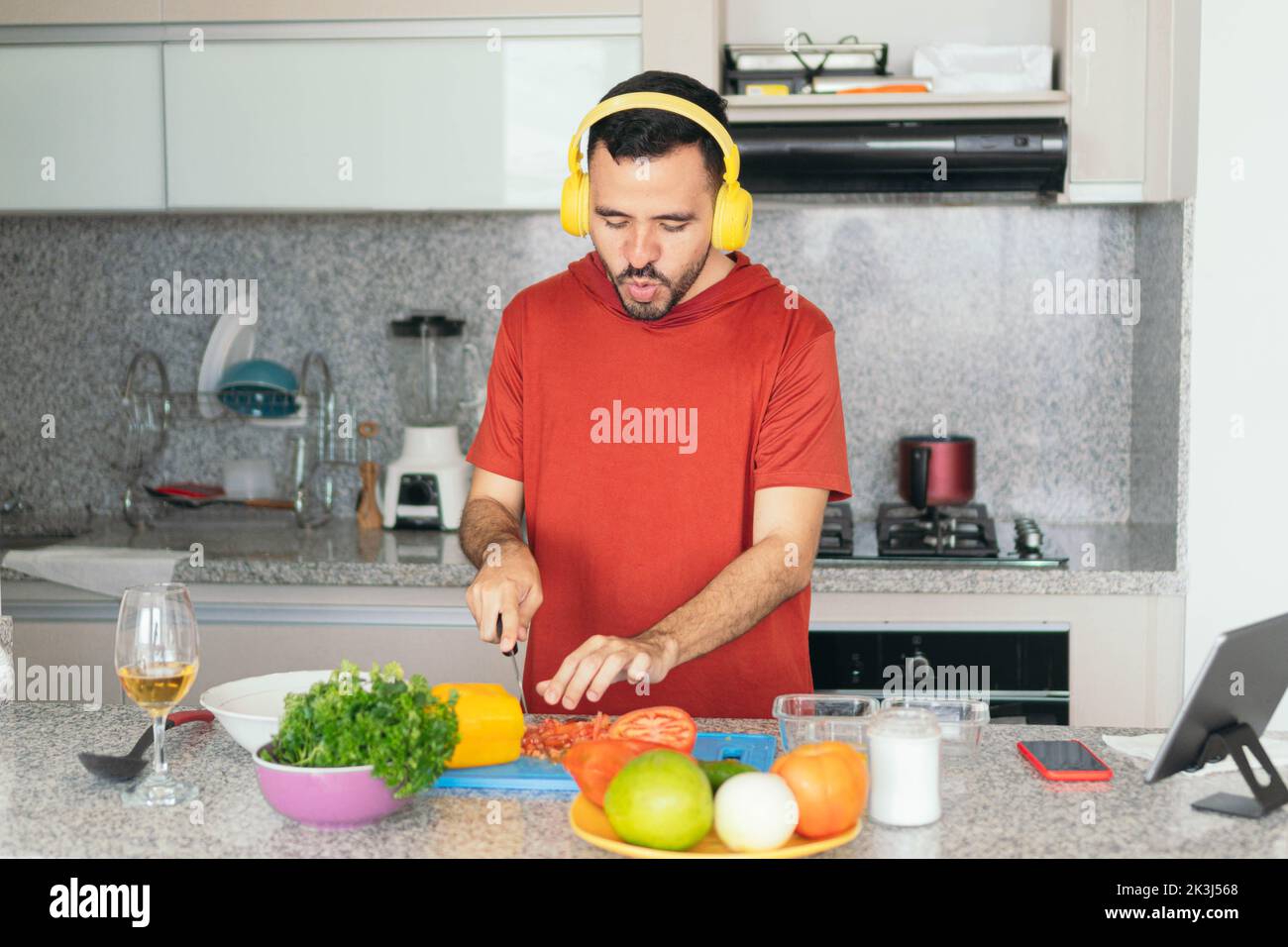 Man listening to music while cooking at home Stock Photo - Alamy
