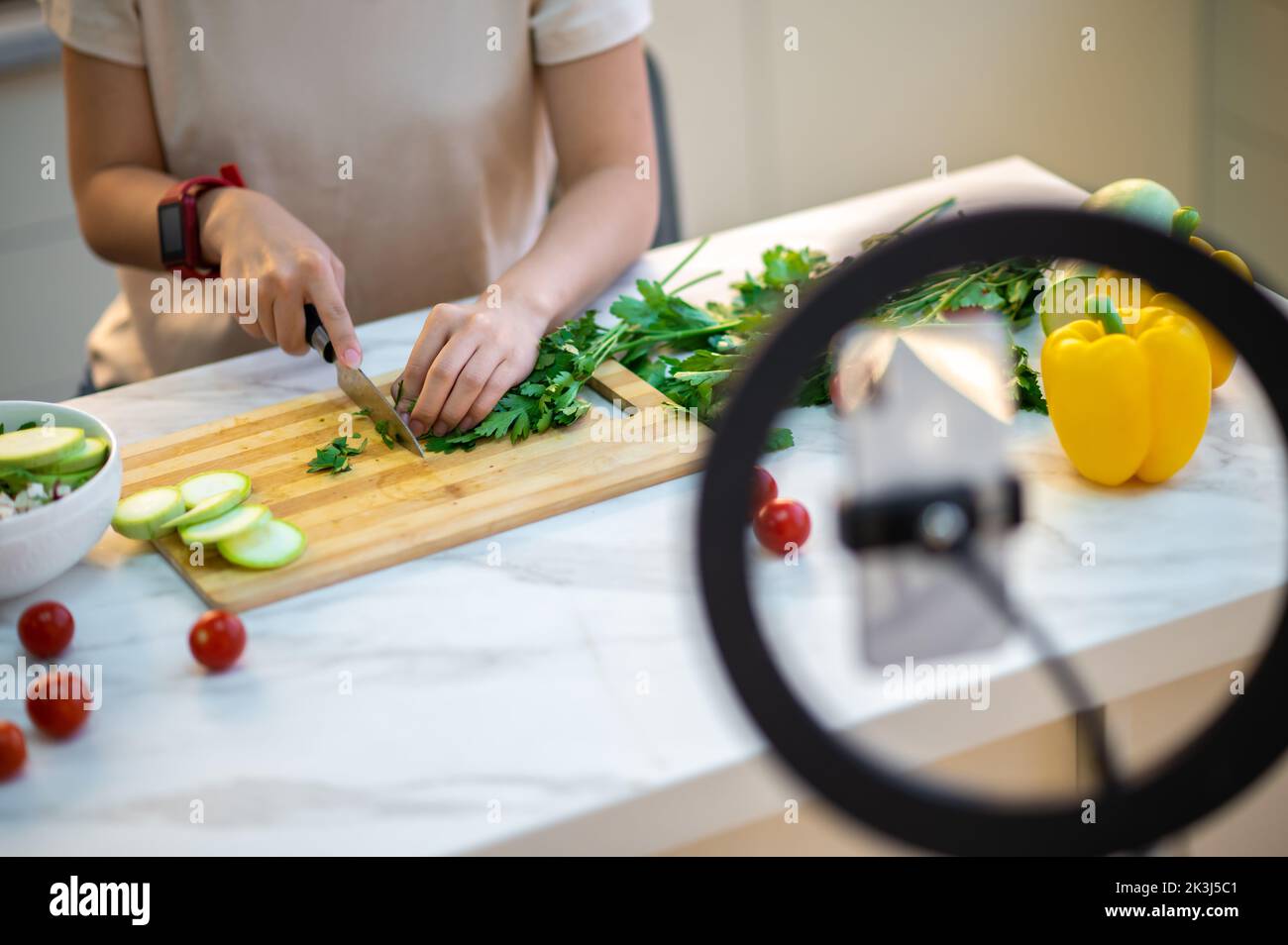 Female vlogger preparing a salad in her cooking show Stock Photo - Alamy