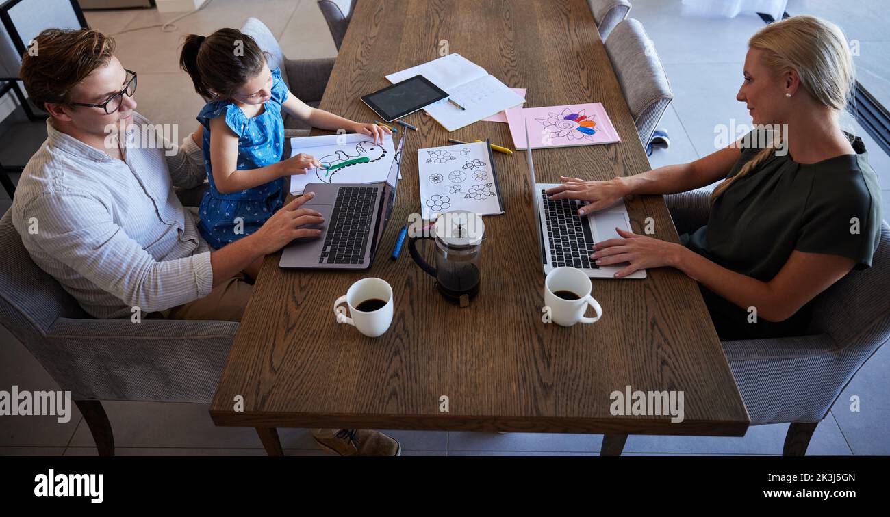 Parents and daughter being productive with remote work and homework ...