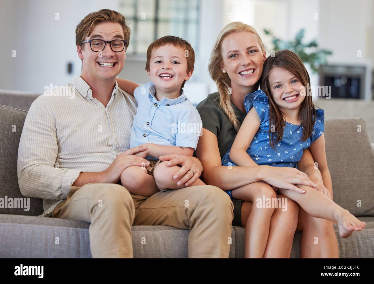 Parents, kids and family portrait in home lounge on sofa together to ...