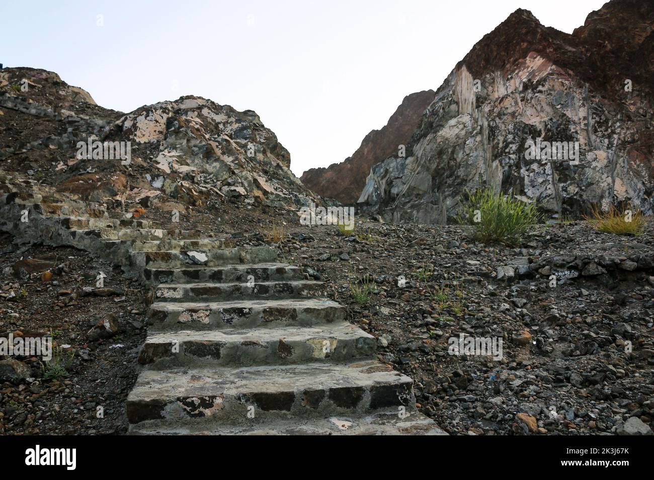 Beautiful deep green Hatta lake with rocky Hajar Mountains on ...