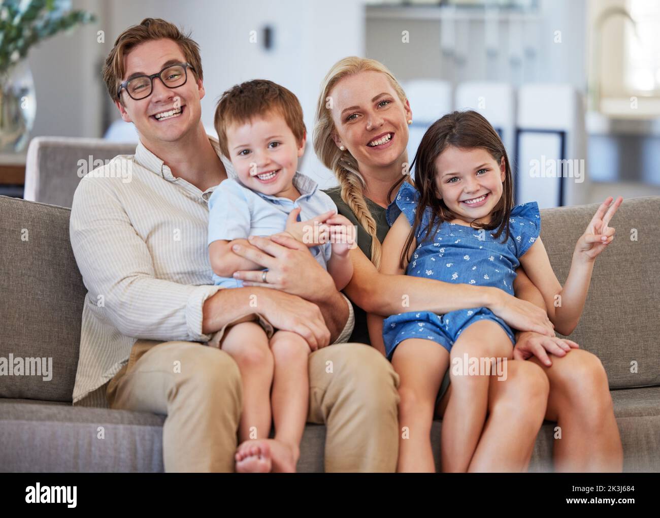 Family, smile and love of children on lap of mom and dad sitting on the ...