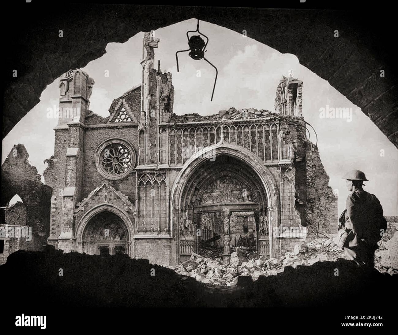 A soldier surveys a ruined church during the 1917 third Battle of Ypres ...