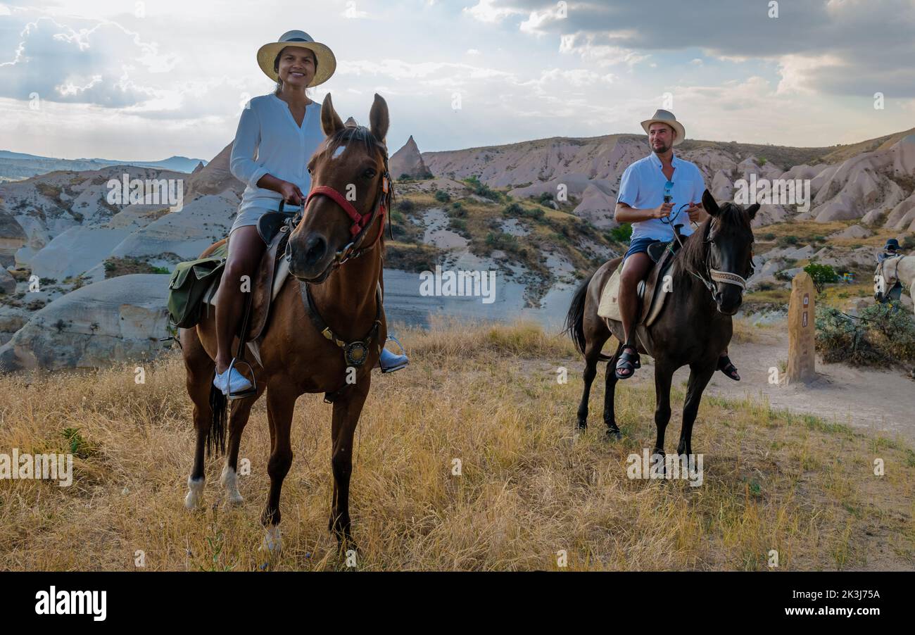 happy young couple on vacation in Turkey Kapadokya horse riding in the ...