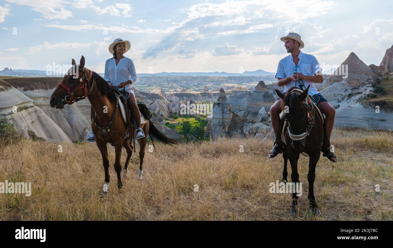 happy young couple on vacation in Turkey Kapadokya horse riding in the ...