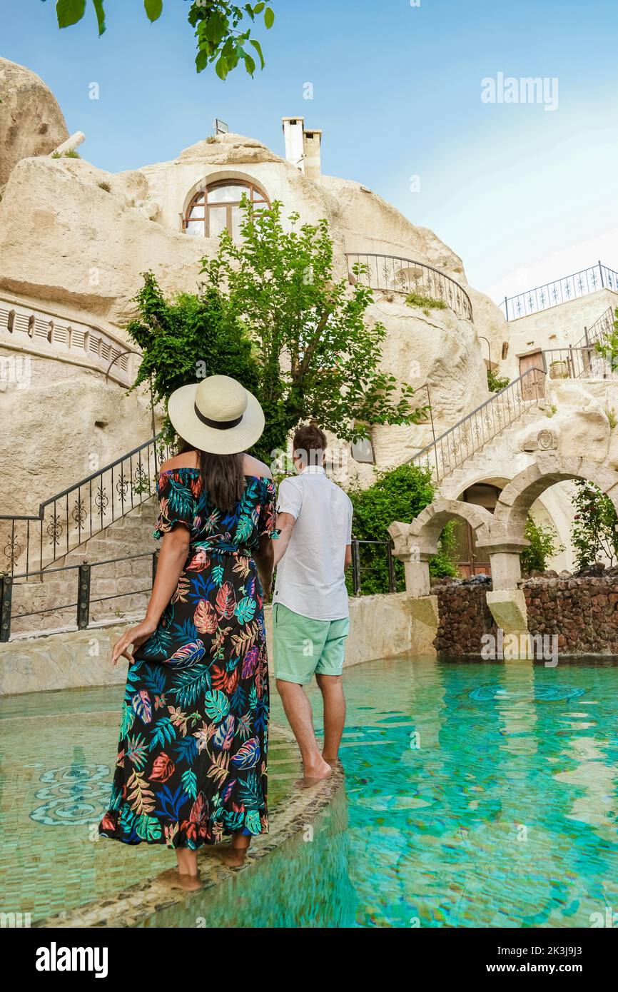 men and woman in dress at cave house, woman infinity pool cave house ...