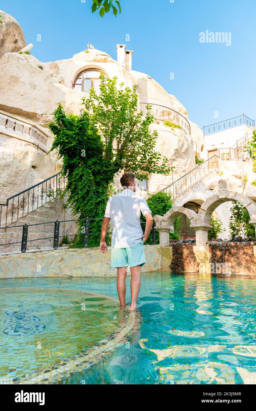 young men at cave house, a guy in infinity pool cave house hotel in the ...