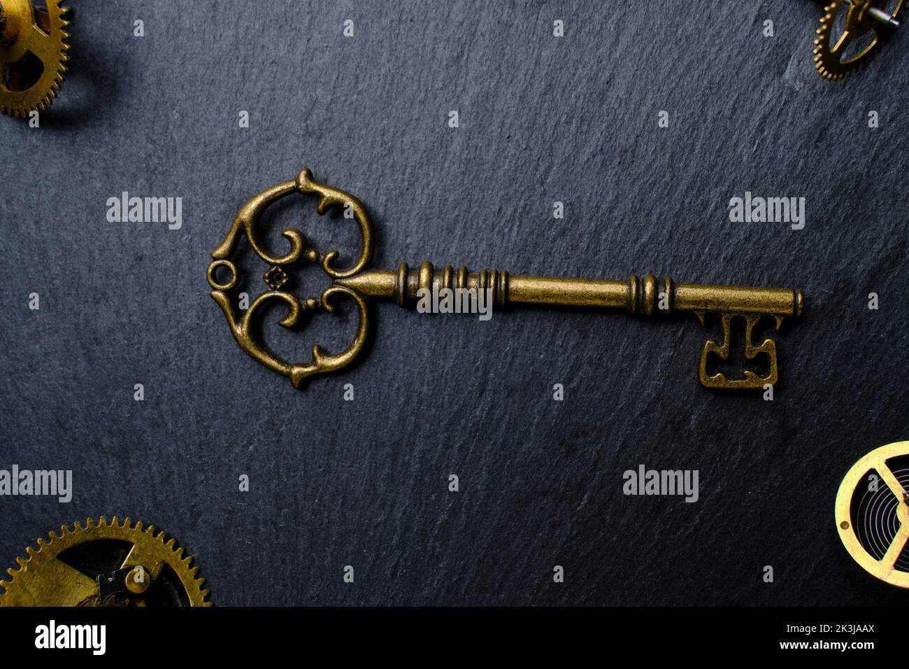 Old vintage key and metal gears dark background Stock Photo - Alamy