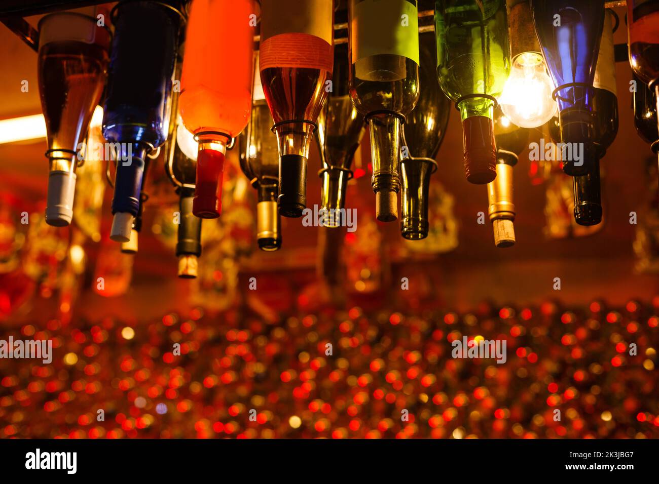 Many inverted bottles hang, close-up shot Stock Photo - Alamy