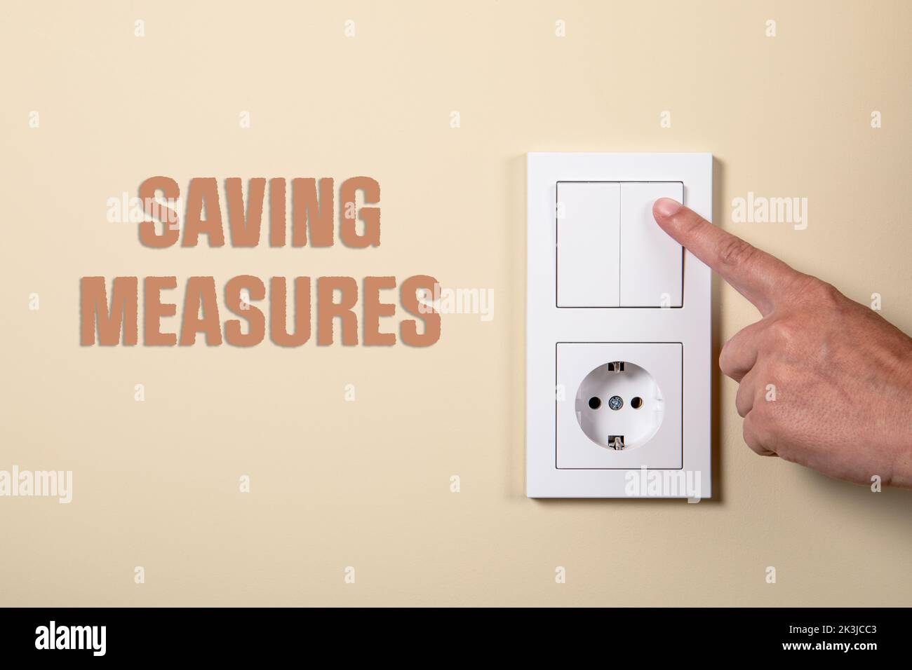 SAVING MEASURES. White light switch and socket Stock Photo - Alamy