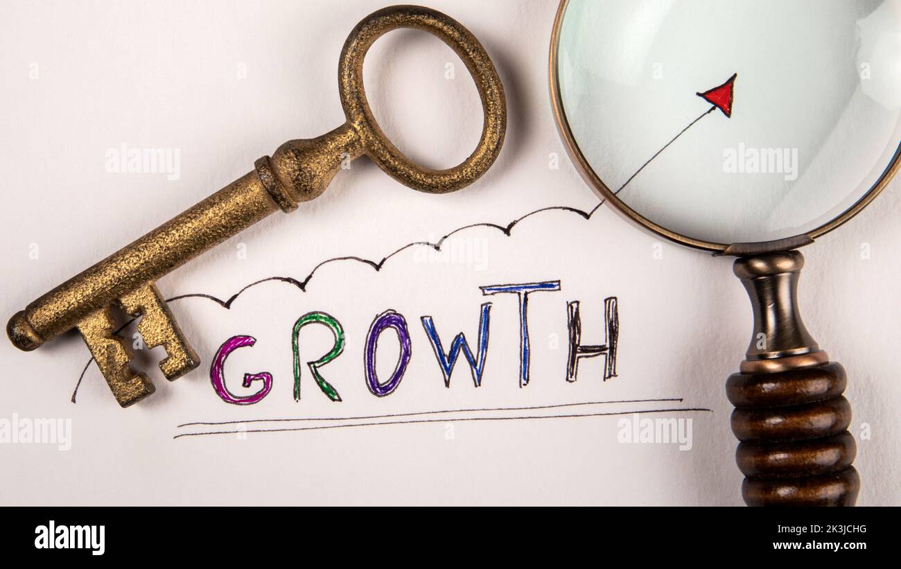 Growth concept. Magnifying glass and door key on white background Stock ...