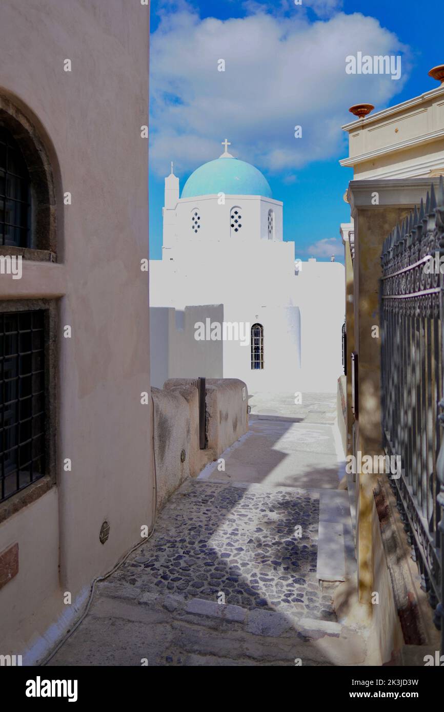 A vertical shot of a typical Greek building with a blue rooftop seen ...