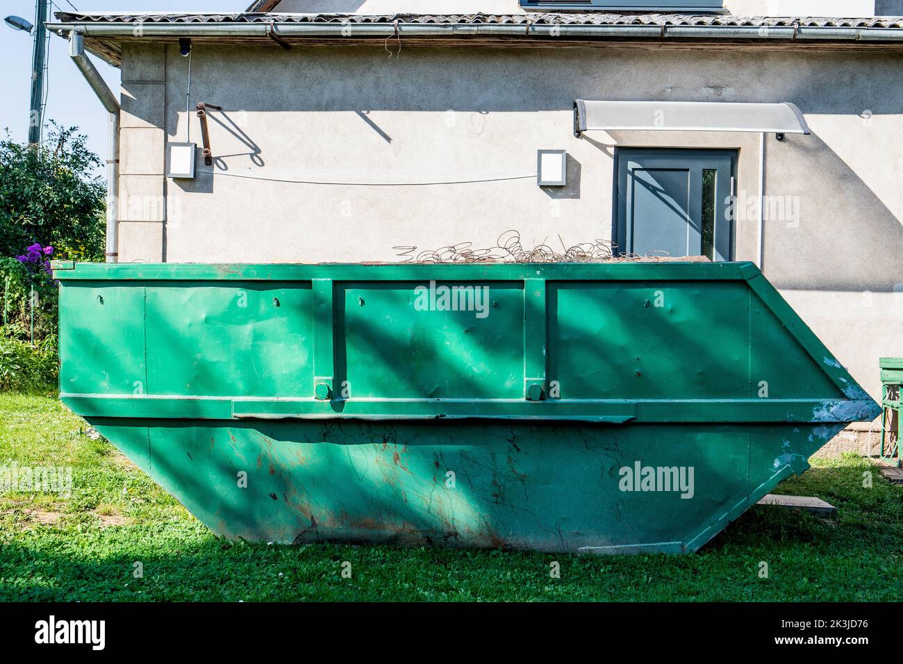 Large metal waste container for construction debris Stock Photo - Alamy