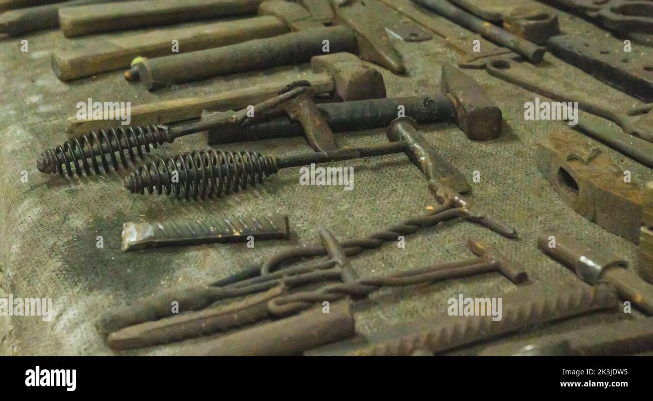 Lots of metal tools to work in the forge. Background, industry ...