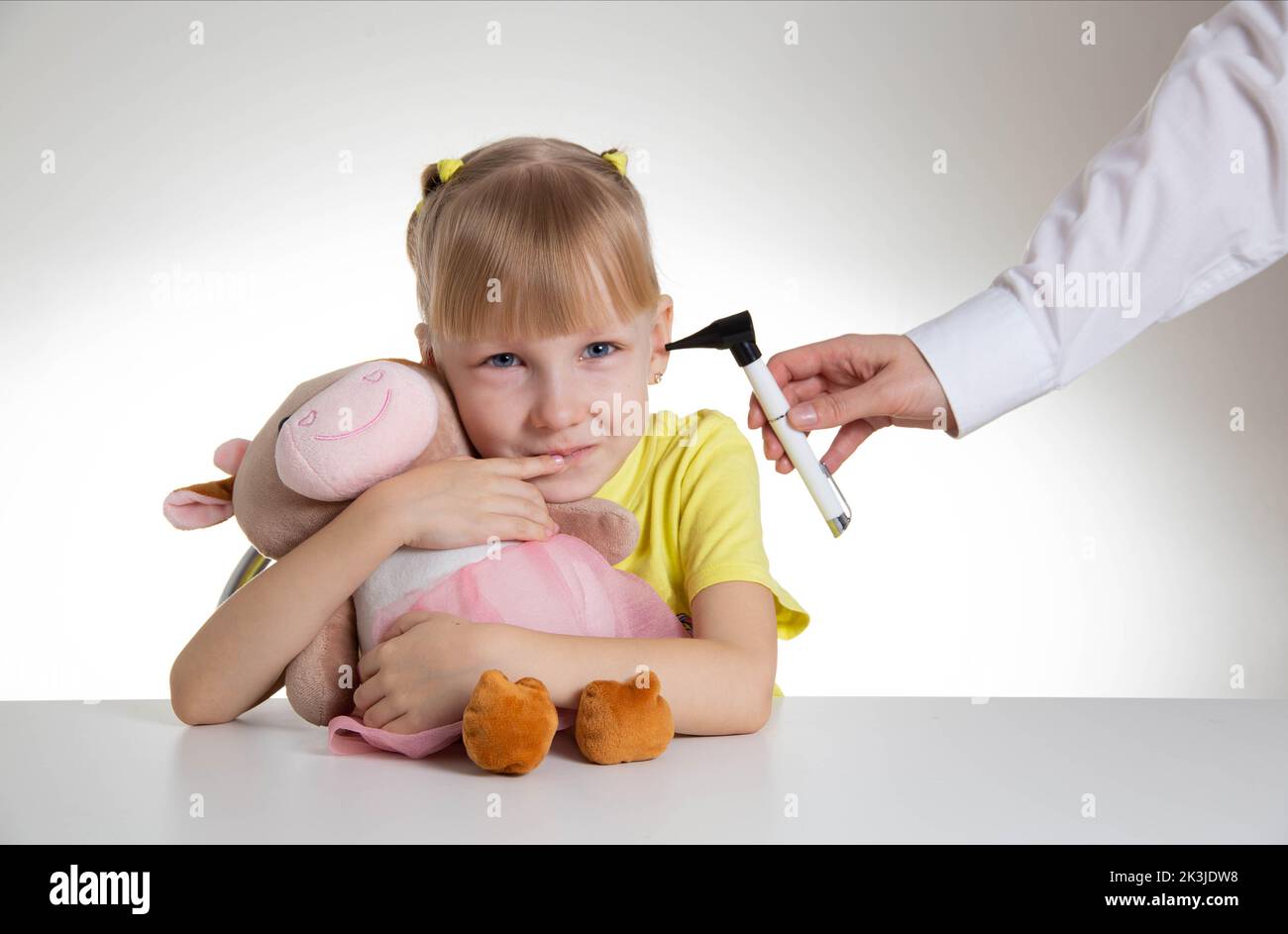 Doctor ENT doctor looks into the ear of a beautiful girl patient at the ...