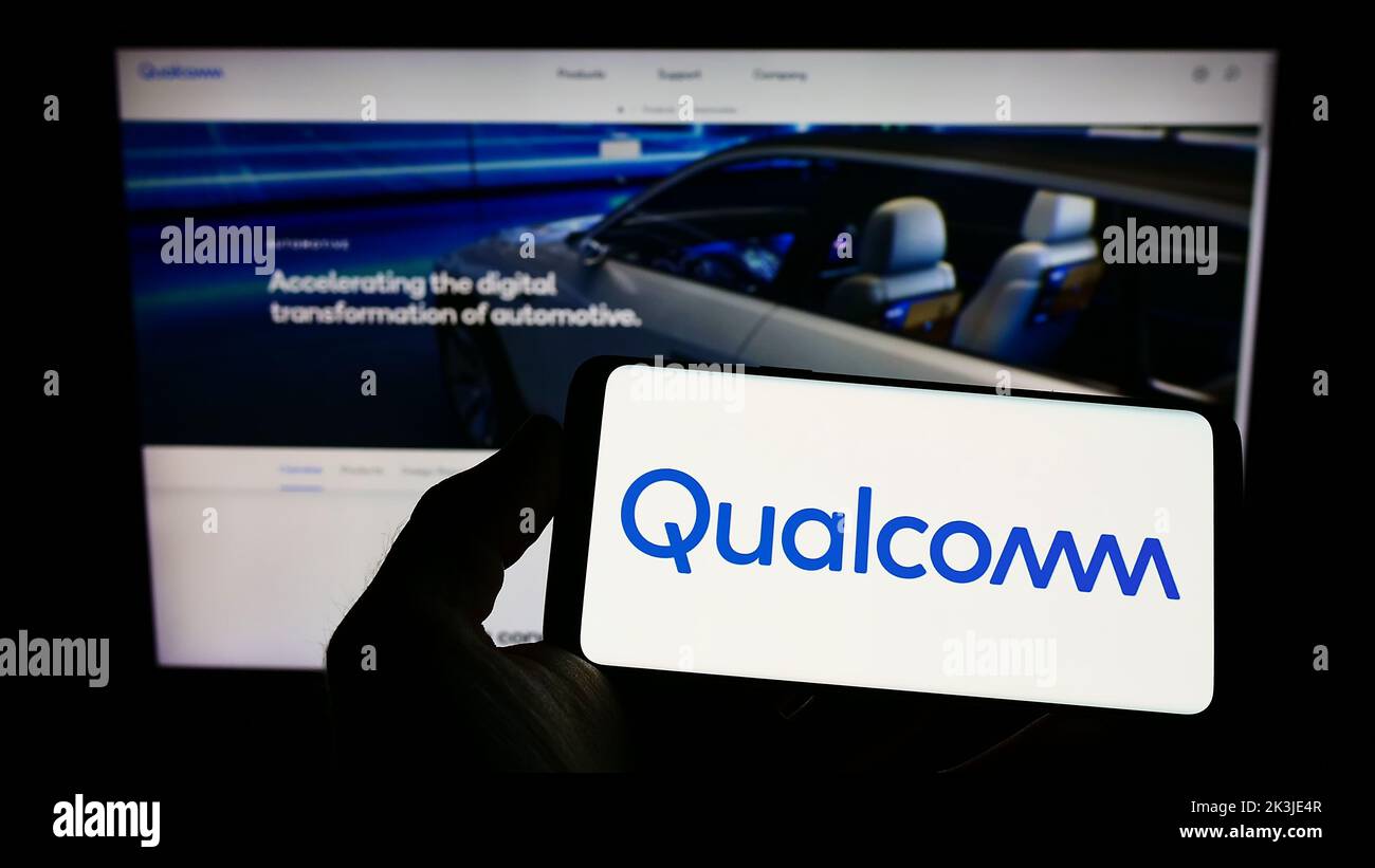 Person holding cellphone with logo of American semiconductor company ...