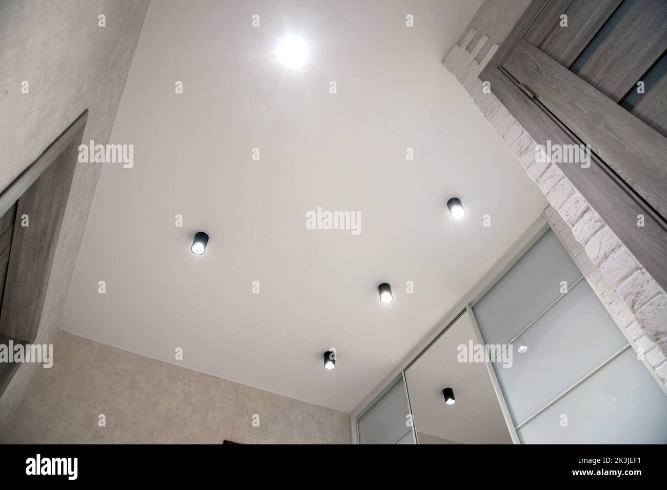 Lots of modern LED spotlights on the stretch ceiling in the hallway ...