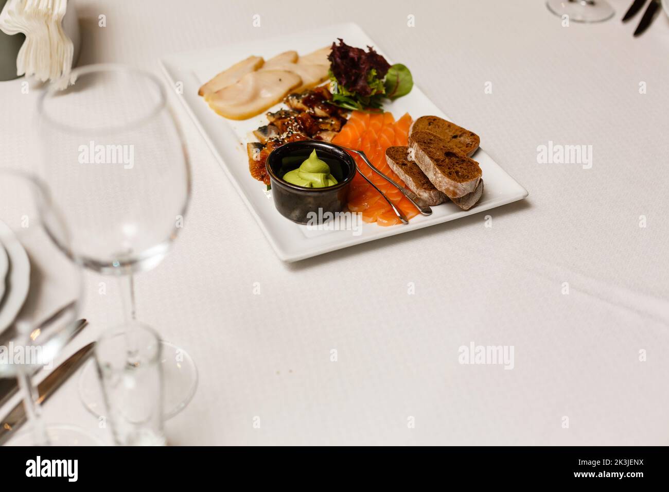 Fish platter in restaurant. Slices of salmon fish, smoked eel, white ...