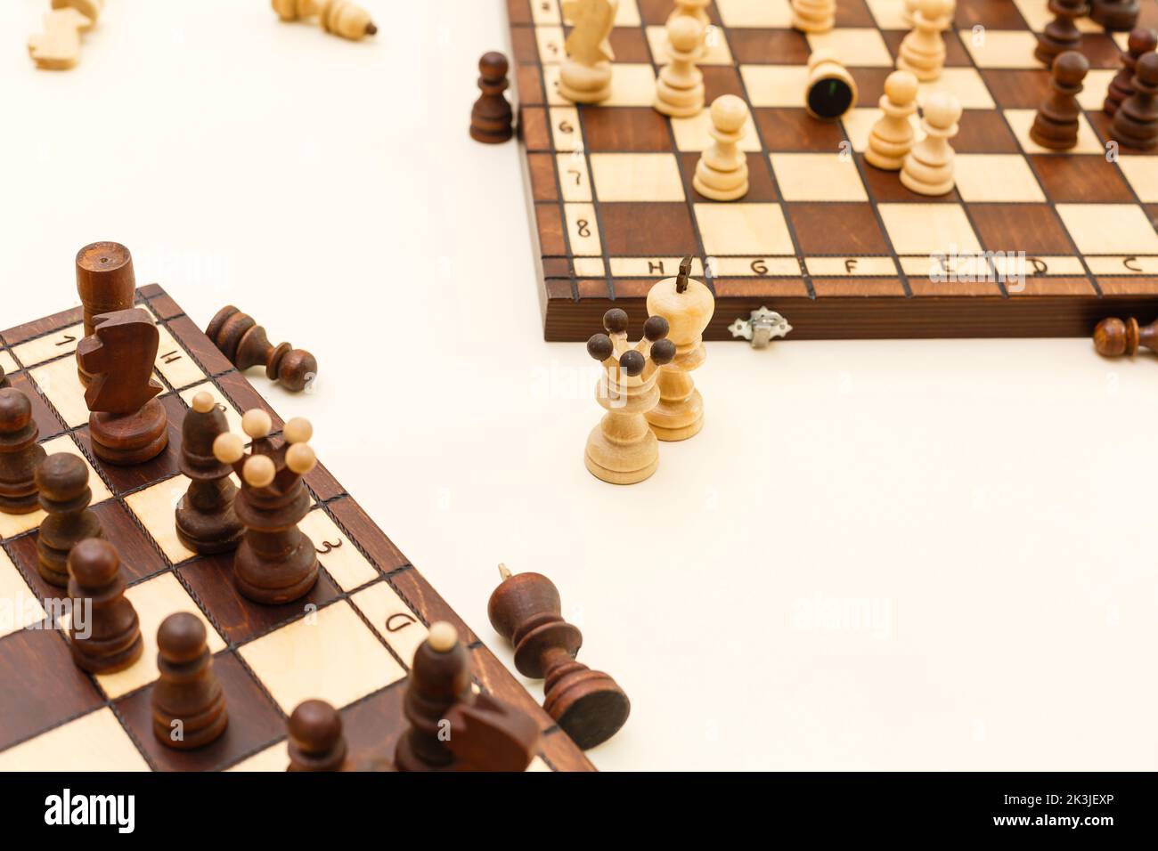 Cropped view of chess board with white and black chess pieces on wooden ...