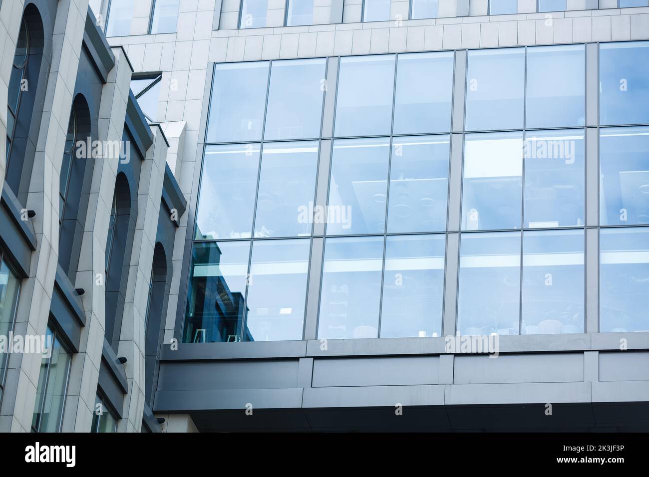 Modern office building. Glass wall. Blue cloudy sky reflecting in ...