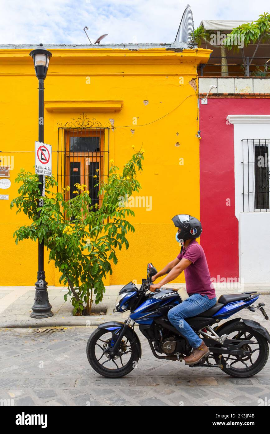 Man on a motorcycle in the historical center of the city of Oaxaca ...