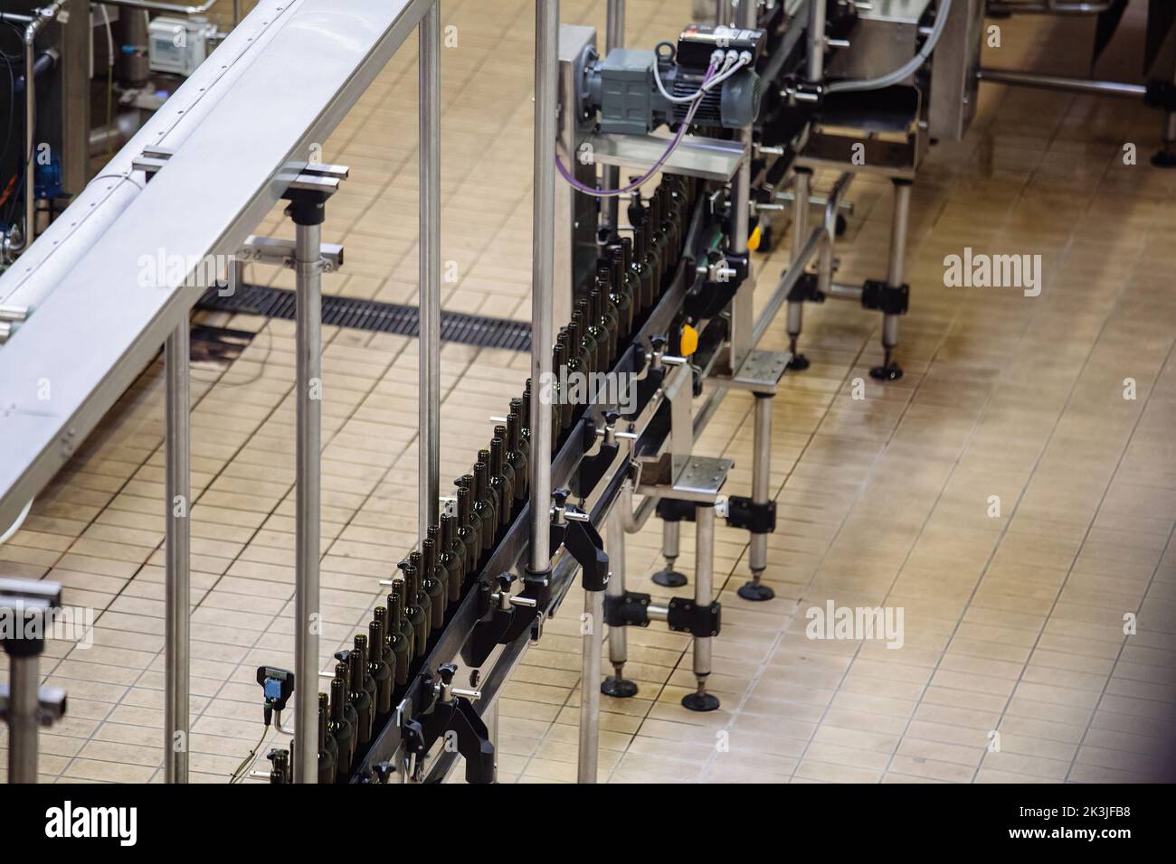 Bottling and sealing wine conveyor production line at modern winery ...