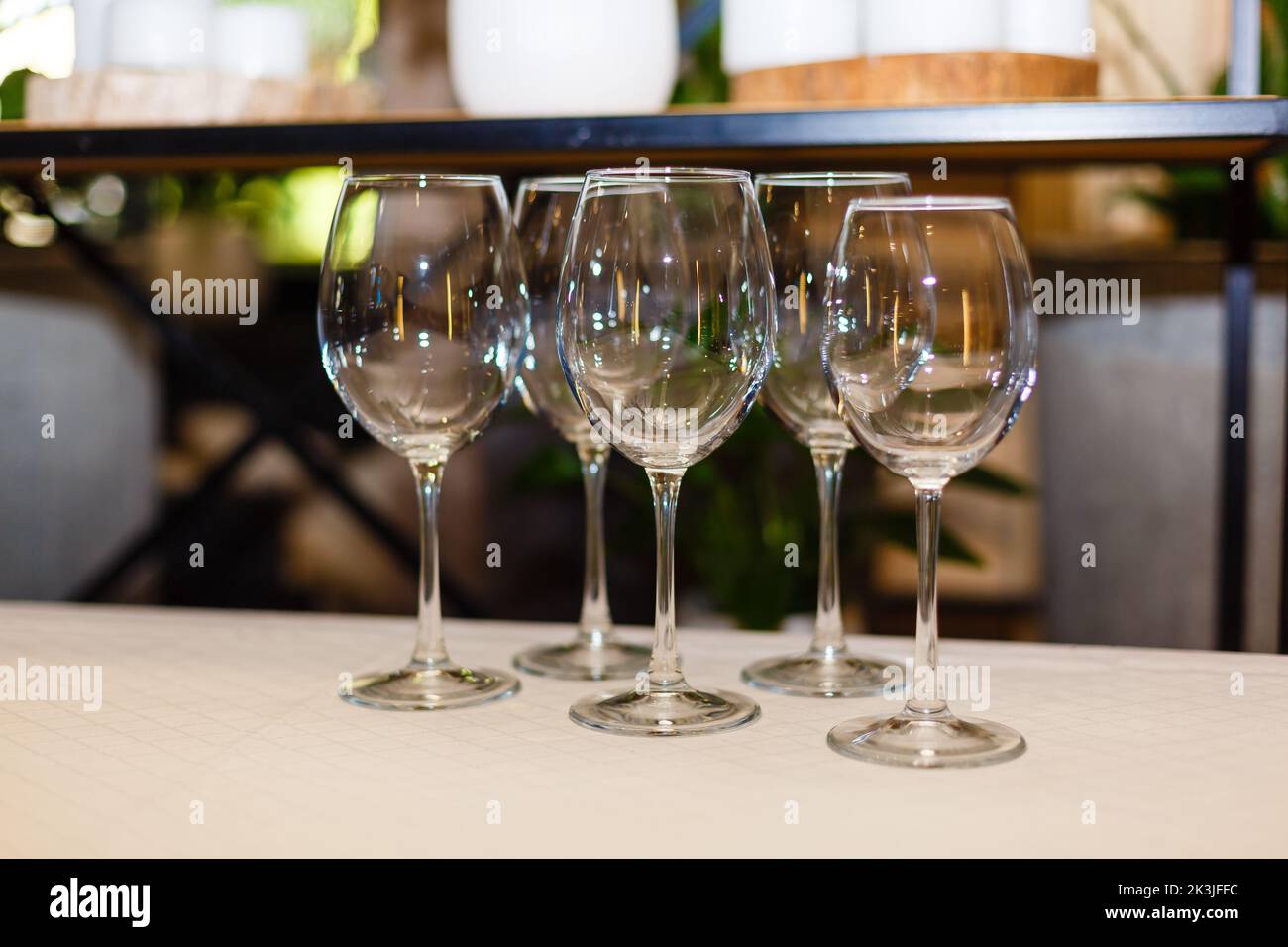 Wine glasses at bar counter. Group of five empty wine glasses ...
