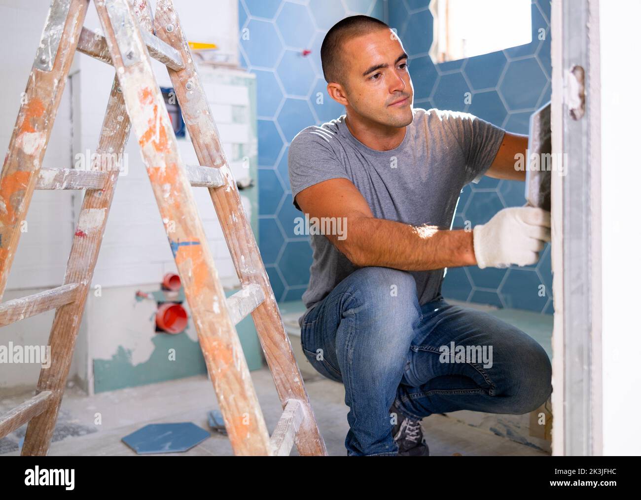 The technology of laying tile, repair and decoration. Focused man puts ...