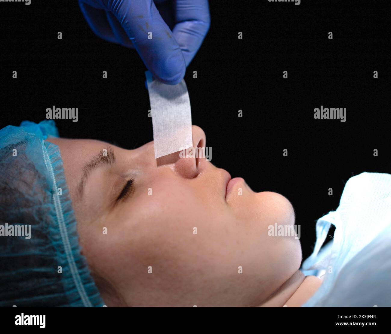 Doctor plastic surgeon conducts an operation of a female patient to ...